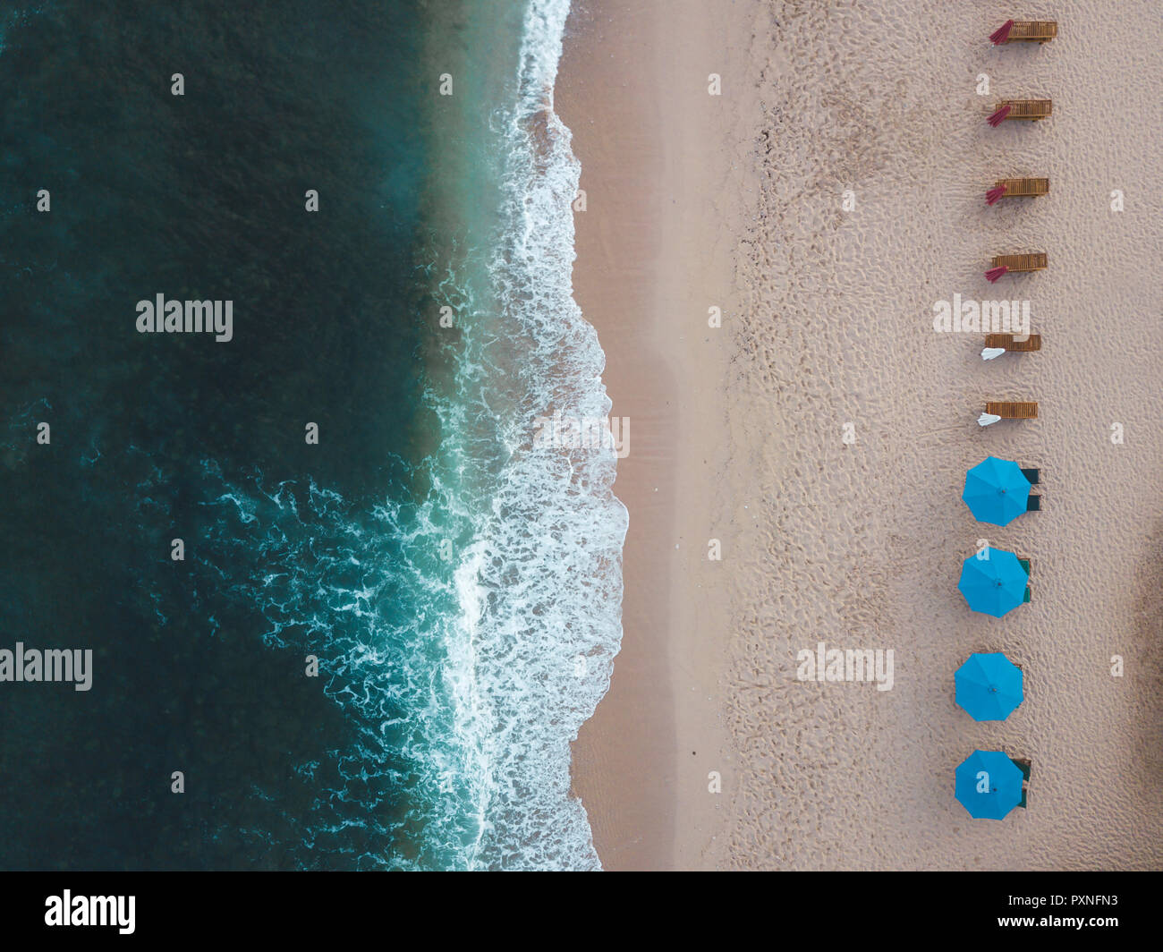 Indonesia, Bali, Aerial view of Balangan beach, empty sun loungers ...