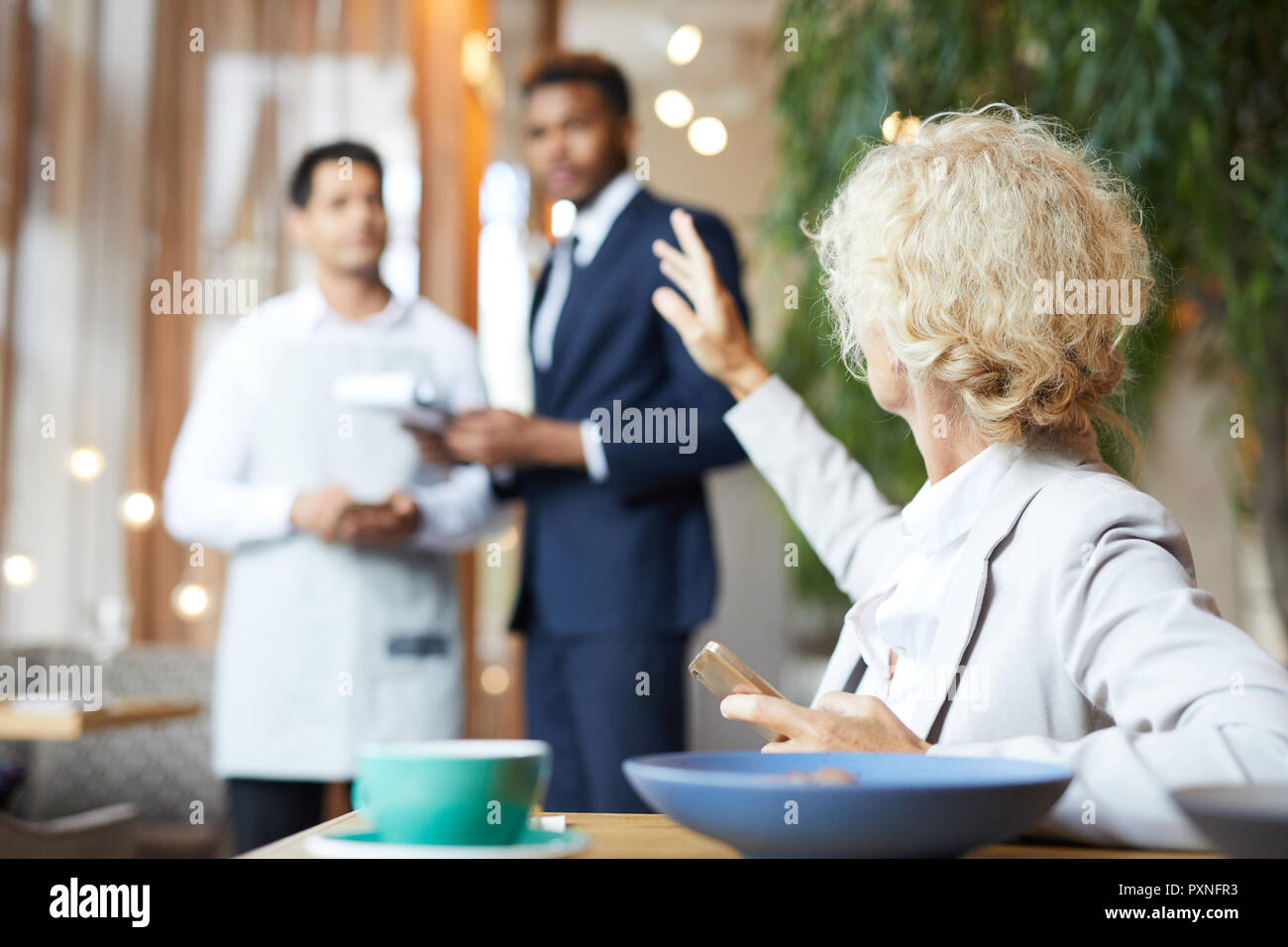 Man calling waiter hi-res stock photography and images - Alamy