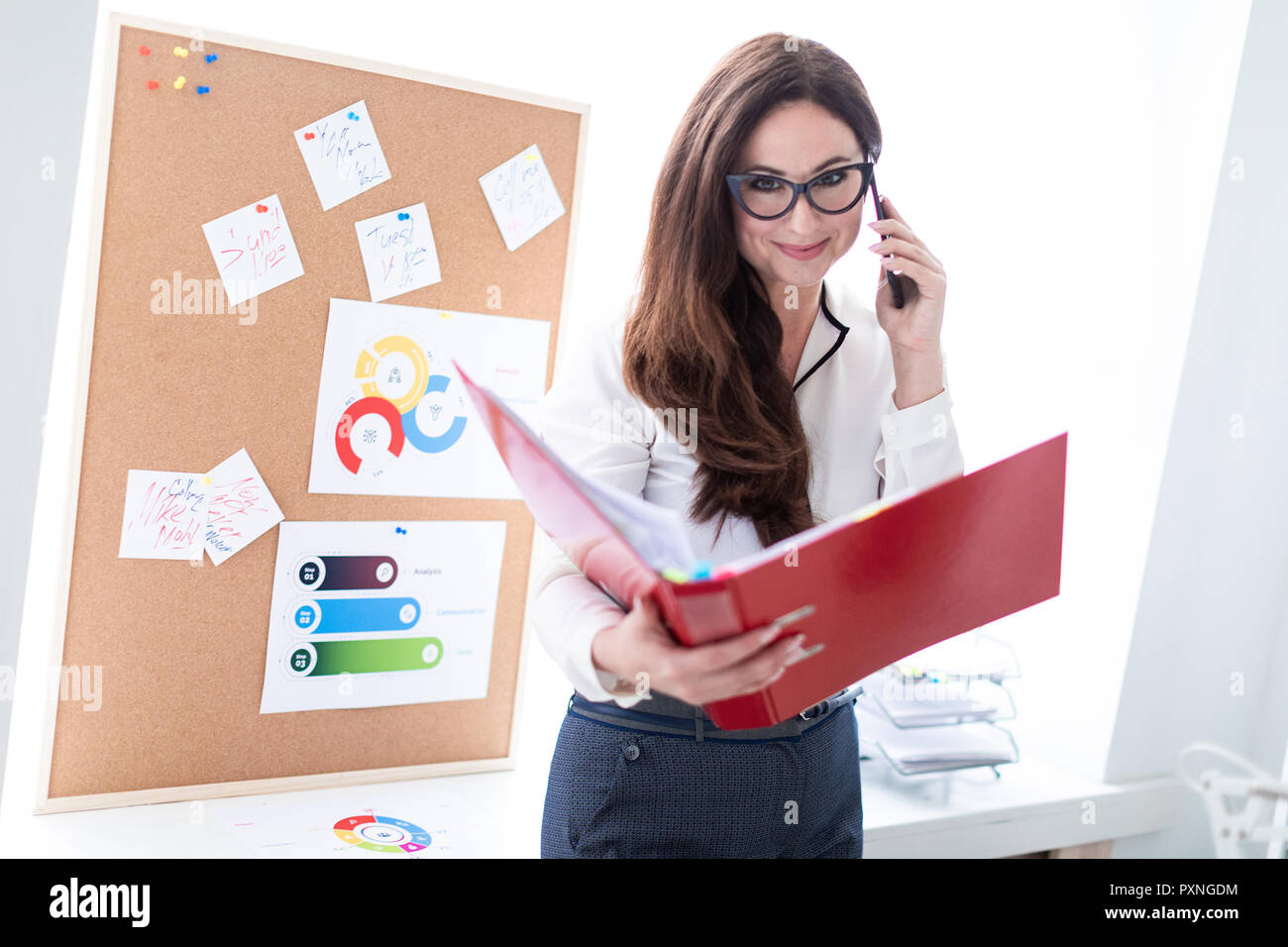 Beautiful girl working in a bright office. The girl is dressed in a ...