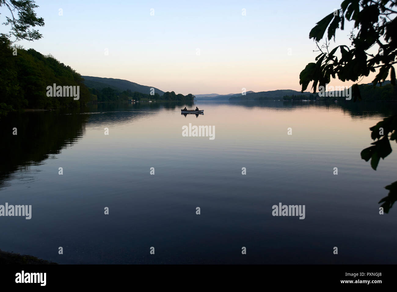 Men fishing in a rowing boat on Coniston Water the Lake District ...
