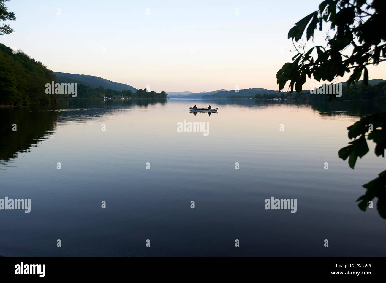 Men fishing in a rowing boat on Coniston Water the Lake District ...