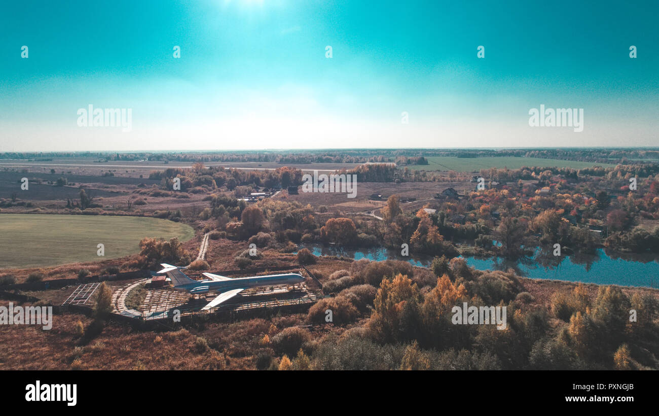 Aerial view of the plane in the autumn forest near the lake and ...