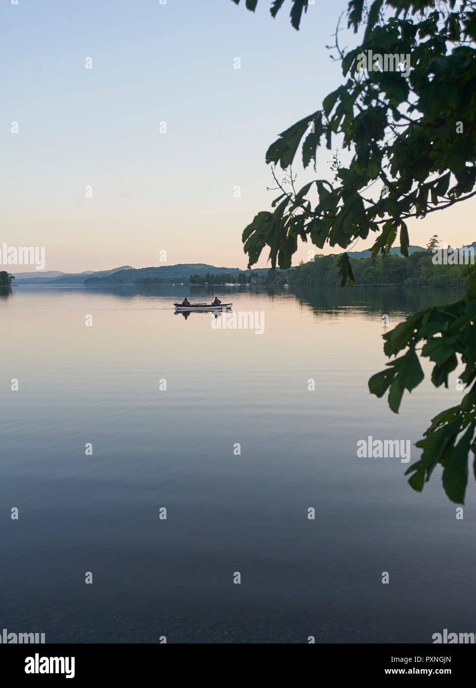 Men fishing in a rowing boat on Coniston Water the Lake District ...