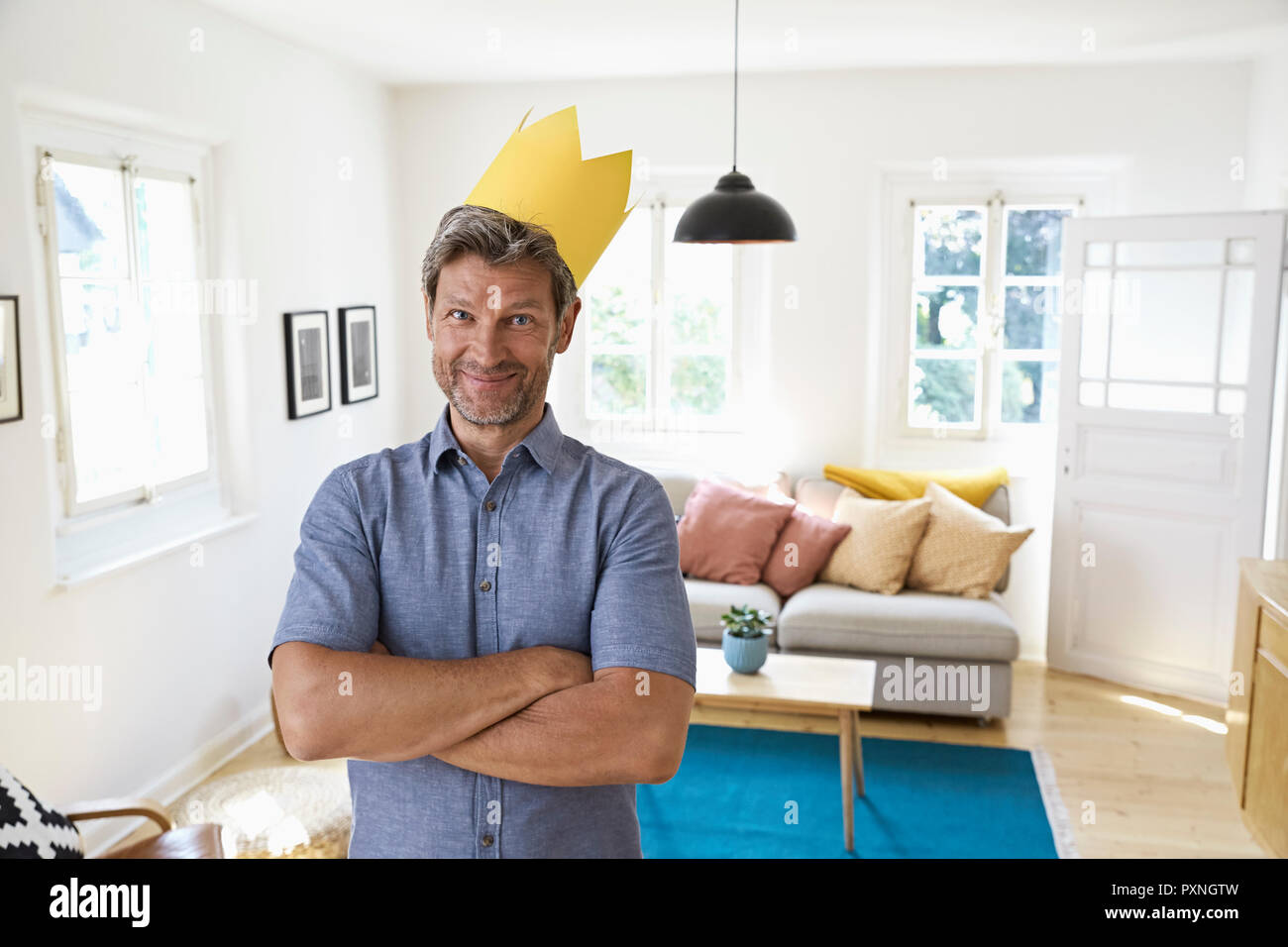 Mature man at home wearing paper crown hi-res stock photography and ...