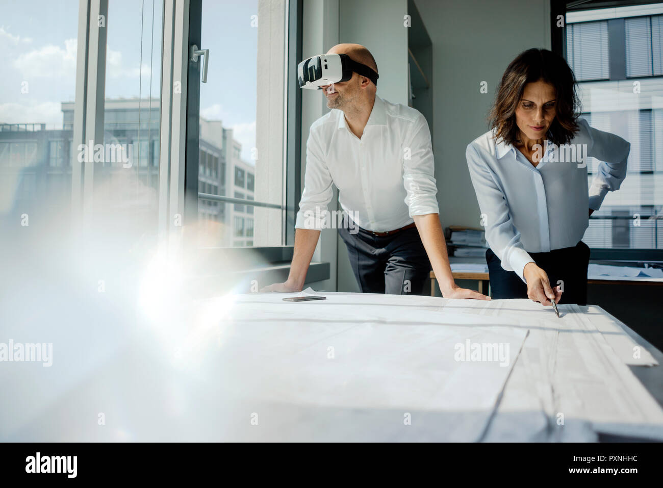 Business people working on blueprints hi-res stock photography and ...