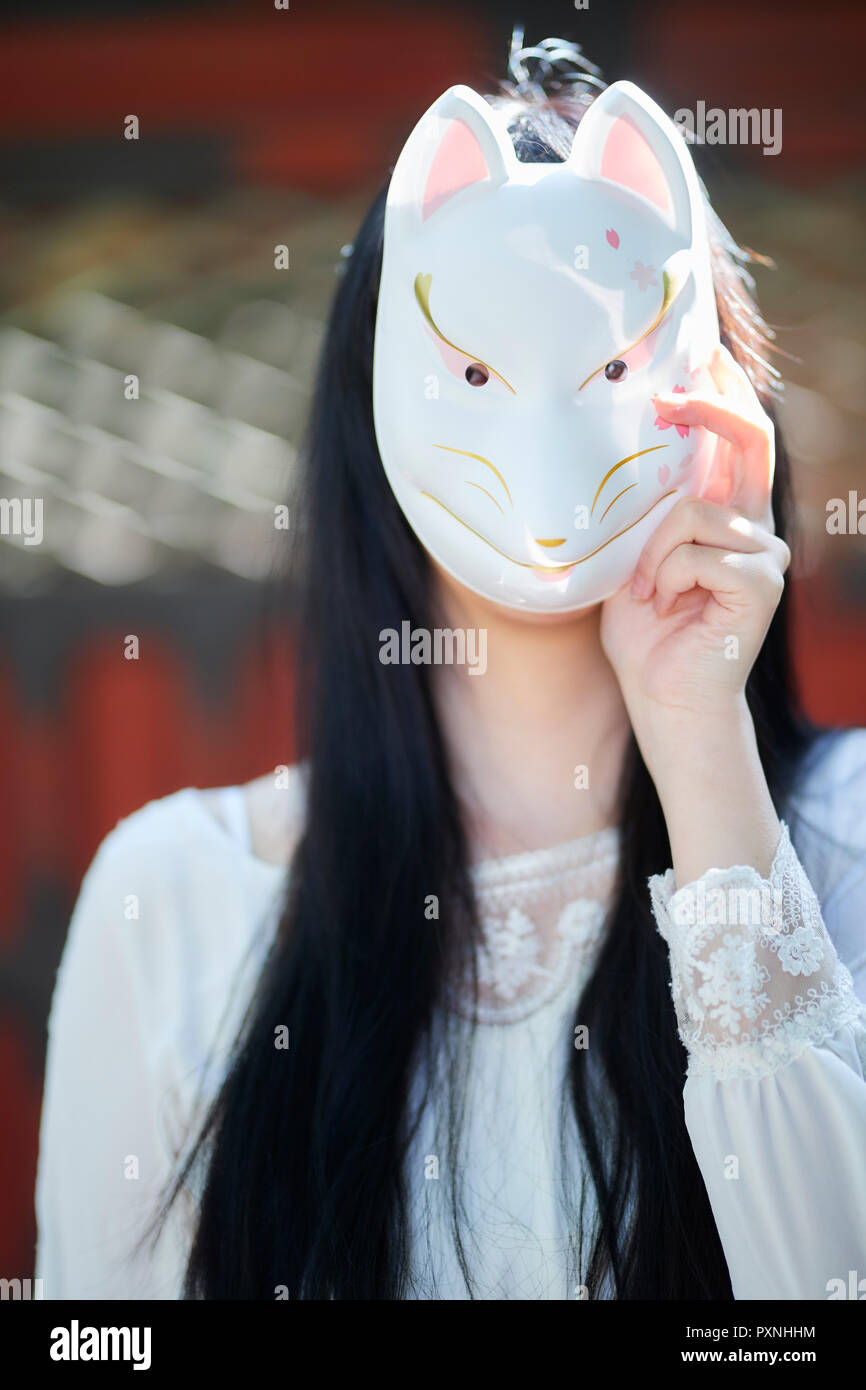 Young Japanese woman with fox mask Stock Photo - Alamy