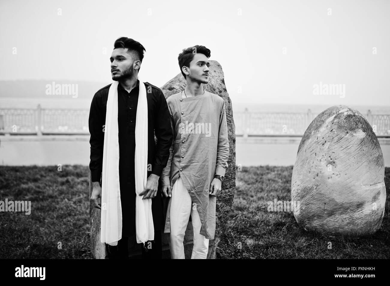 Two indian stylish mans friends in traditional clothes posed outdoor ...