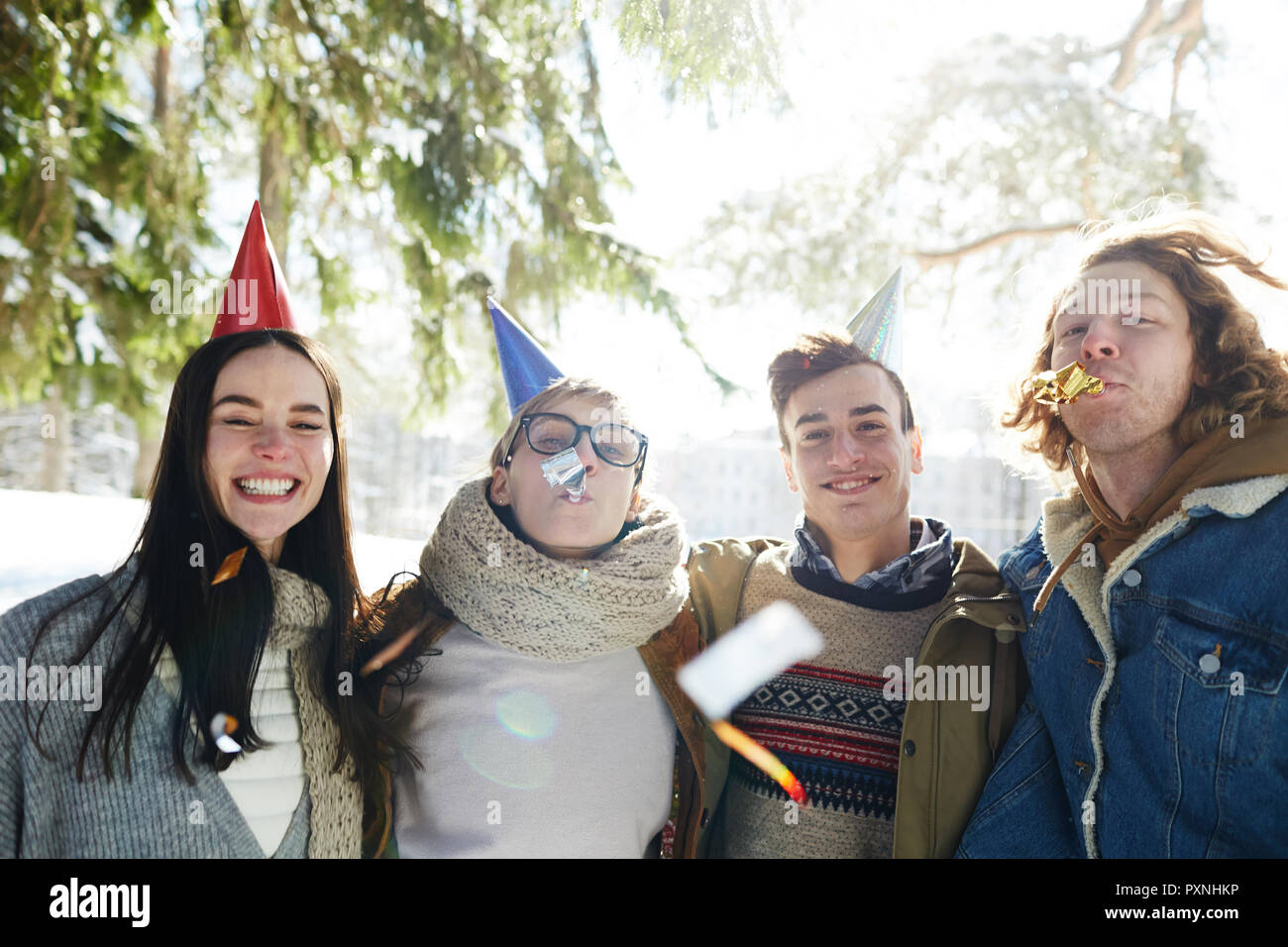 Group of happy young people celebrating Christmas outdoors in beautiful ...