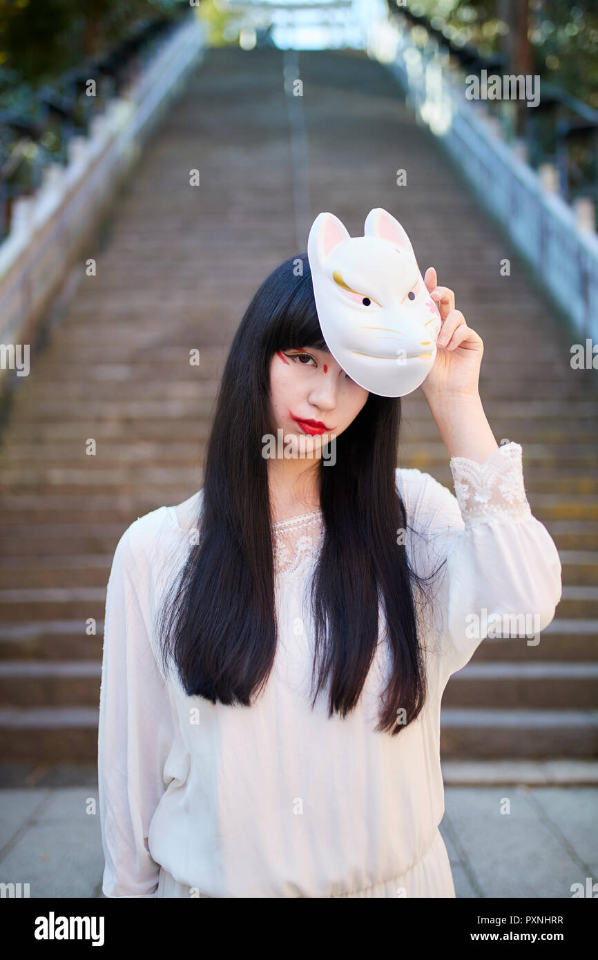 Young Japanese woman with fox mask Stock Photo - Alamy