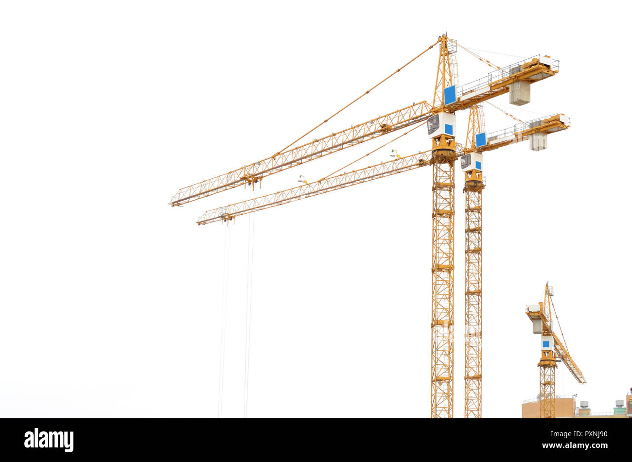 Construction crane on white background.It is used to lift loads at the ...