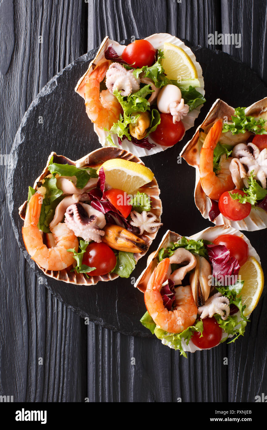 Healthy snack salad of seafood shrimp, baby octopus, mussels and ...