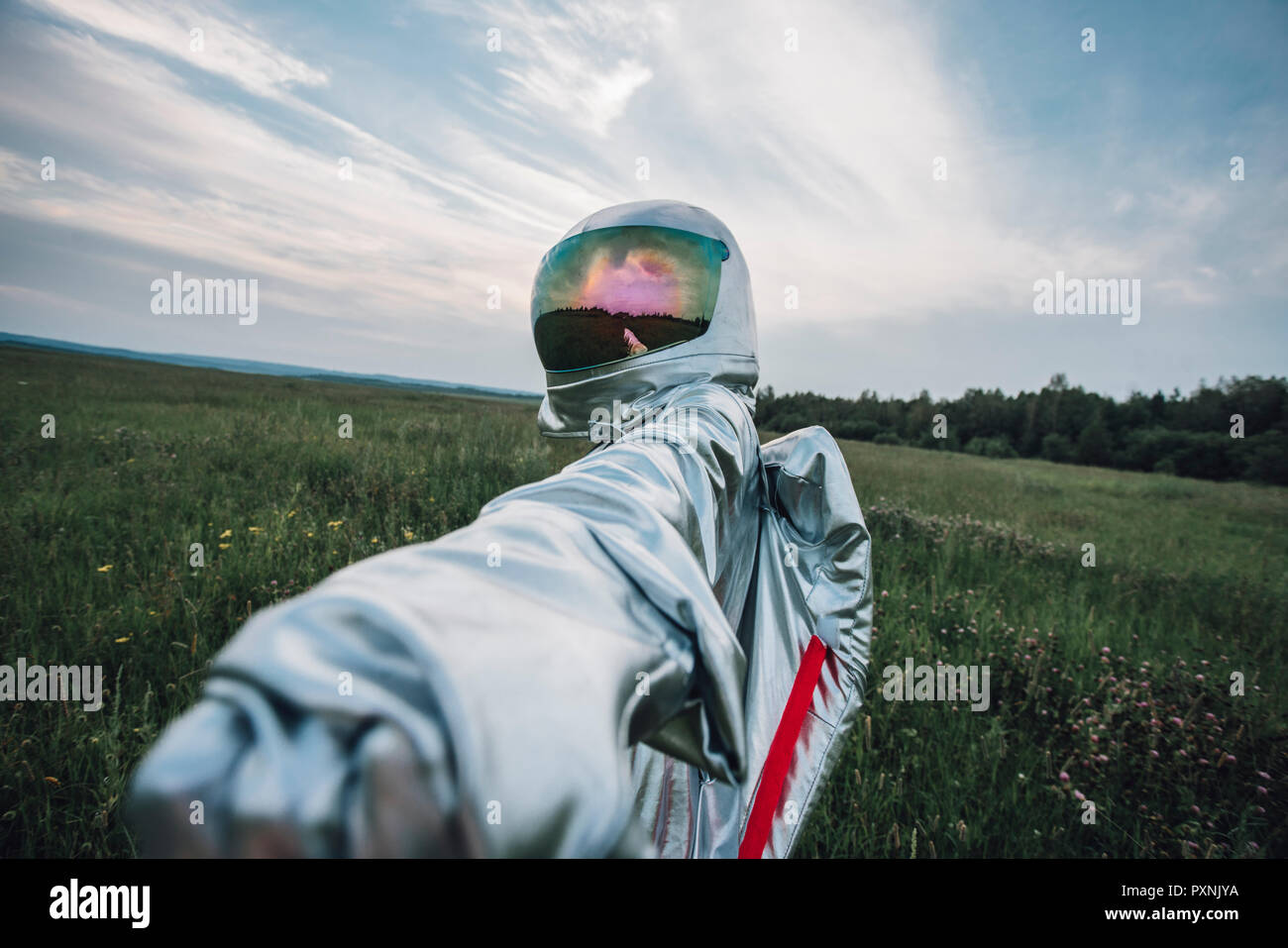 Spaceman exploring nature, reaching out hand Stock Photo - Alamy