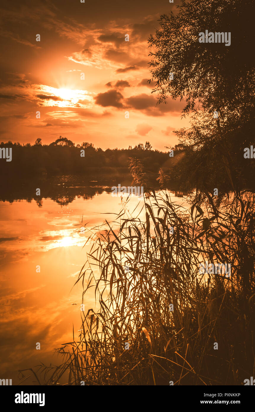 Sunset over a river delta in fall. Autumn evening landscape with a lake ...