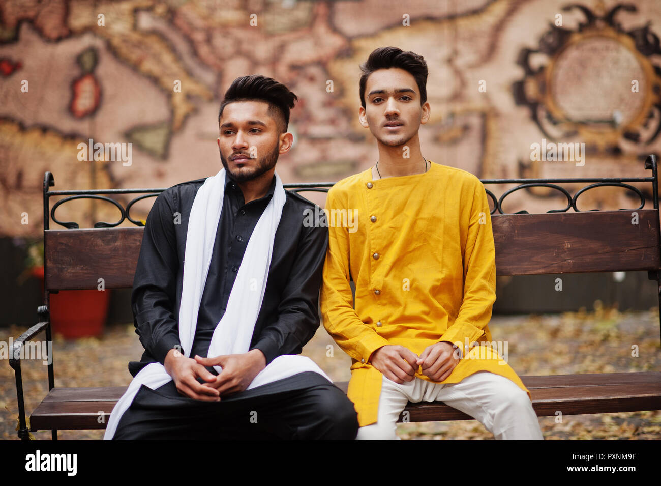 Two indian stylish mans friends in traditional clothes posed outdoor ...