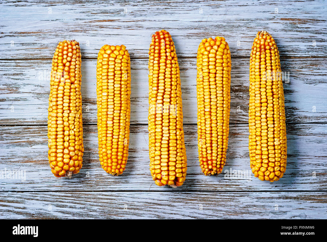 Raw corn shakes on the table, top view Stock Photo - Alamy