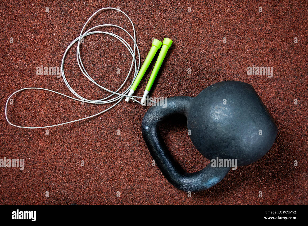 Sports kettlebell and jump rope on a red background in the gym Stock ...