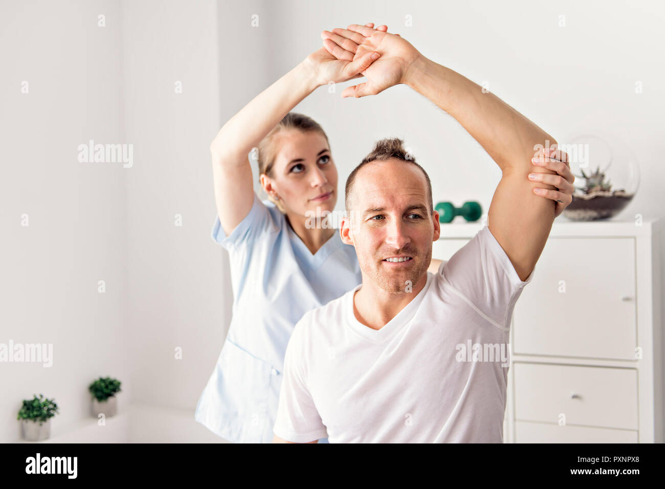 Patient at the physiotherapy doing physical exercises with his ...