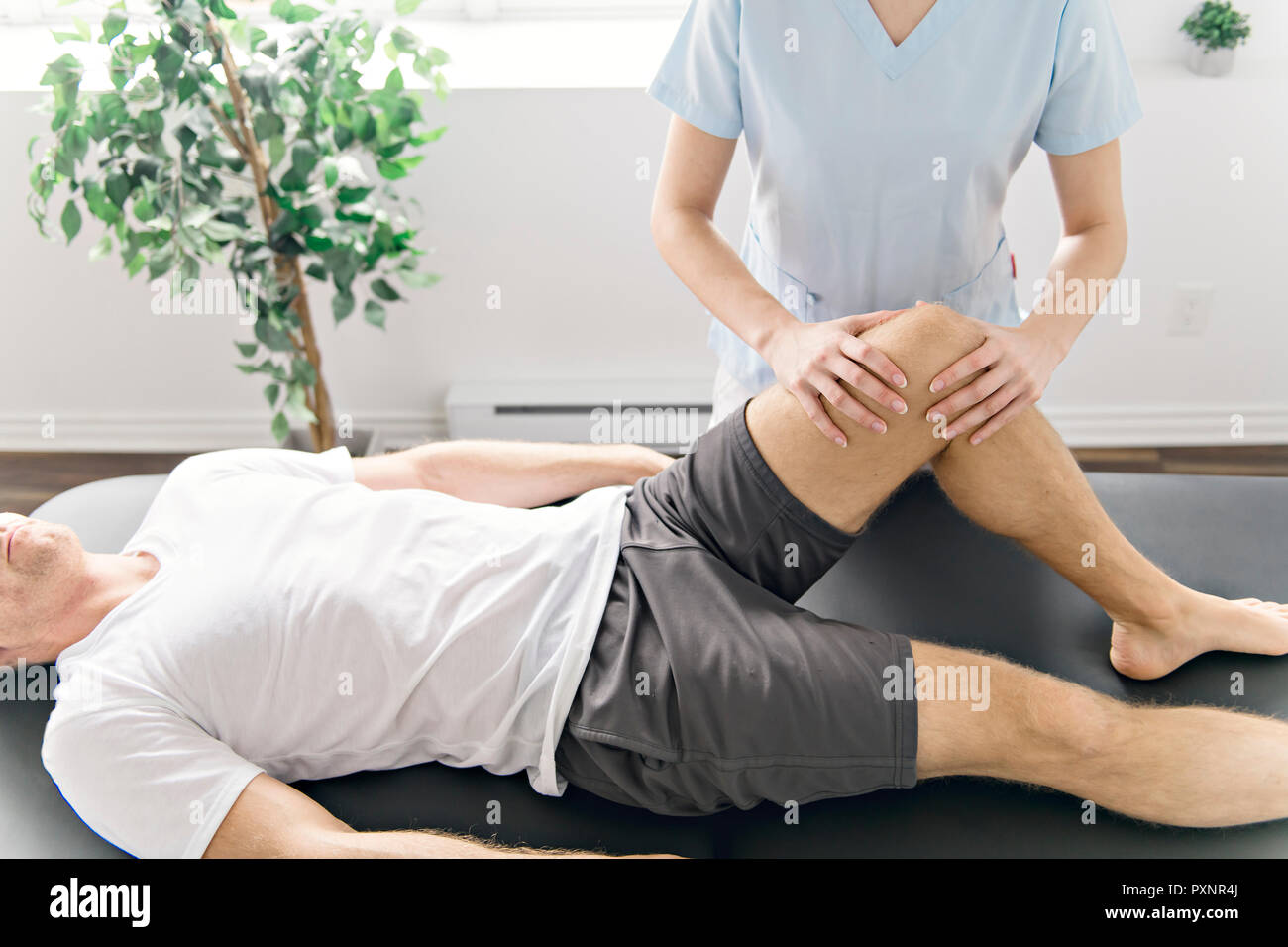Patient at the physiotherapy doing physical exercises with his ...