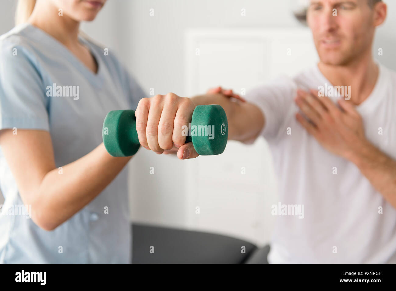 Patient at the physiotherapy doing physical exercises with his ...