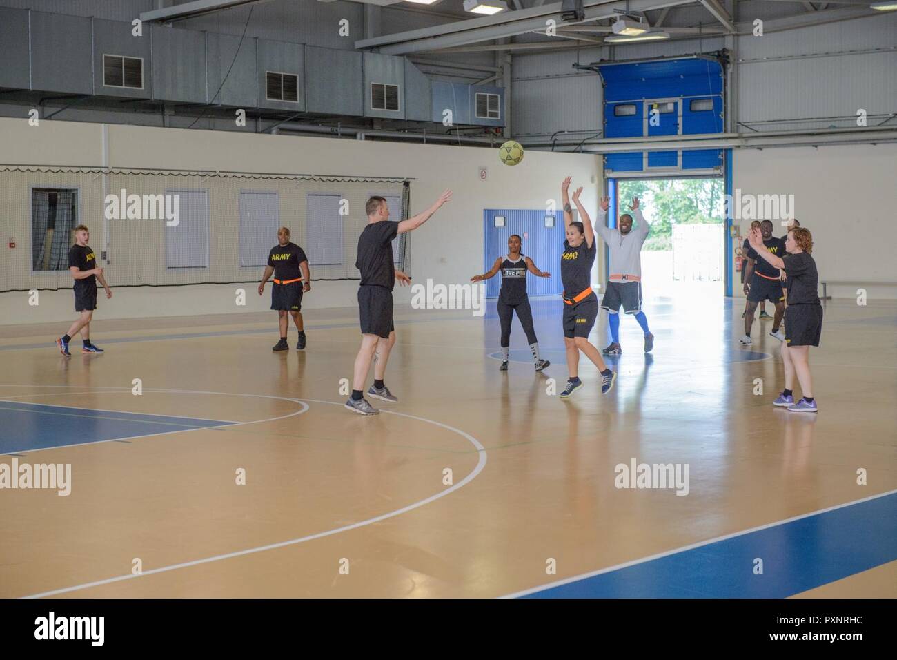 U.S. Soldiers and civilians jump to catch a ball as members of 39th ...