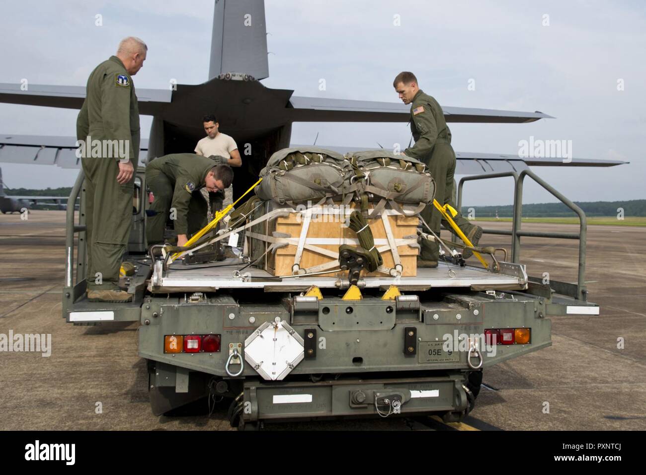 Loadmasters from the 327th Airlift Squadron check a heavy equipment ...