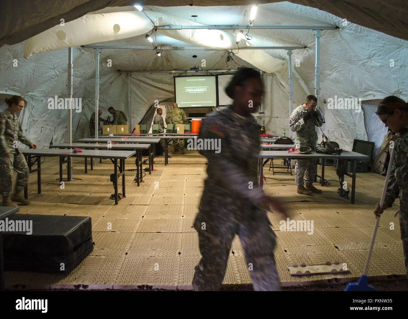 Soldiers with the 158th Maneuver Enhancement Brigade set up the ...