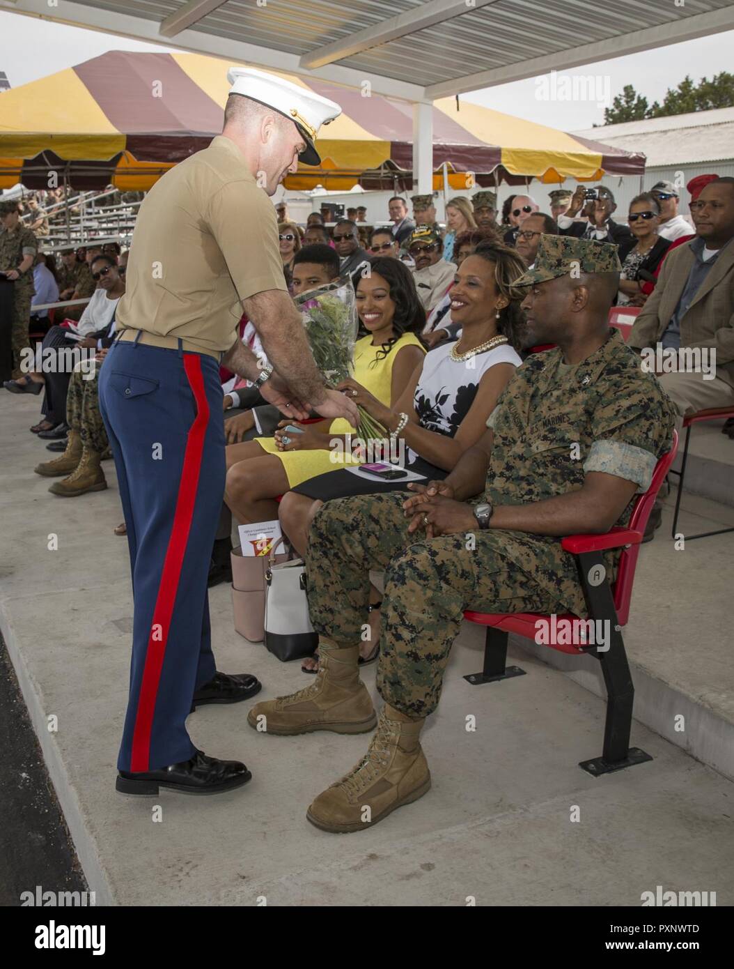 Flowers are presented to the wife of U.S. Marine Corps Col. Ahmed T ...