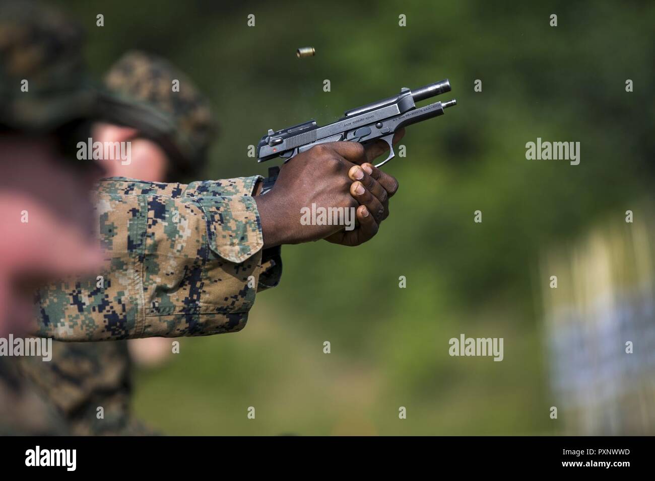 A U.S. Marine with Marine Corps Embassy Security Group (MCESG) fires ...