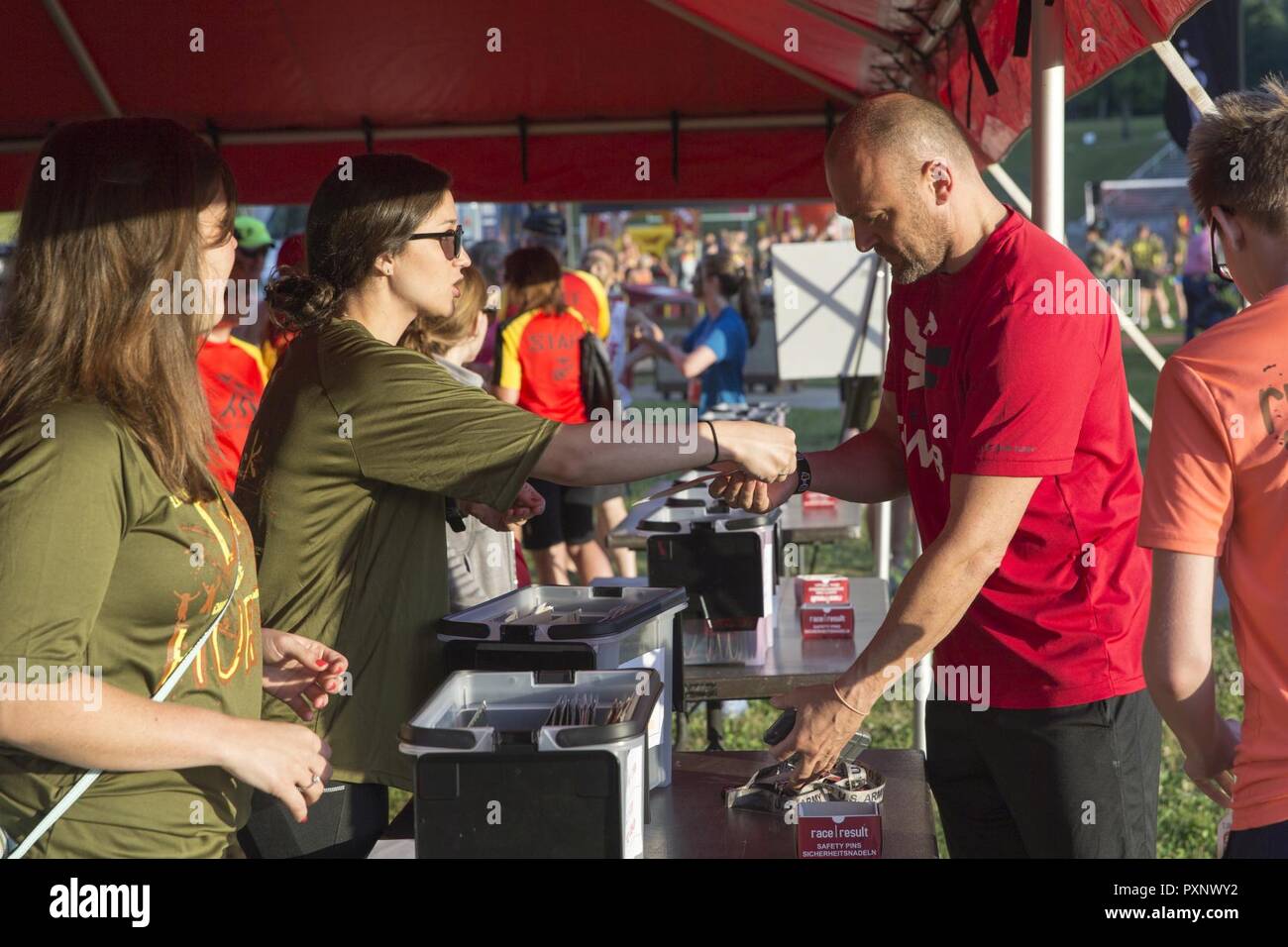 A Marine Corps Marathon (MCM) employee hands out race numbers during ...