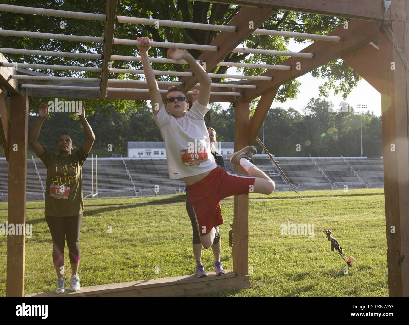 Participants engage in an obstacle during the annual Marine Corps ...