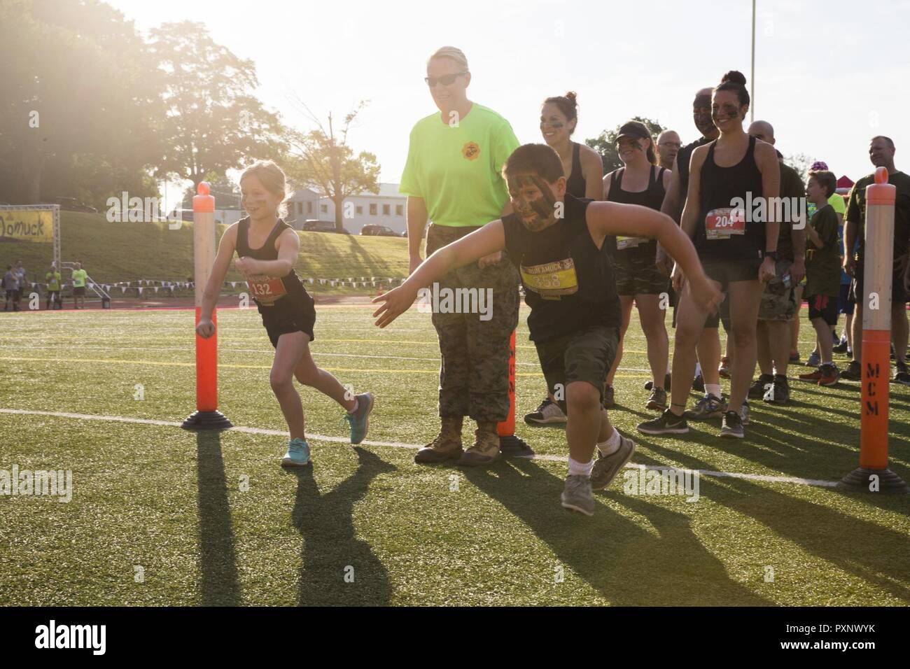 Participants run to an obstacle during the annual Marine Corps Marathon ...