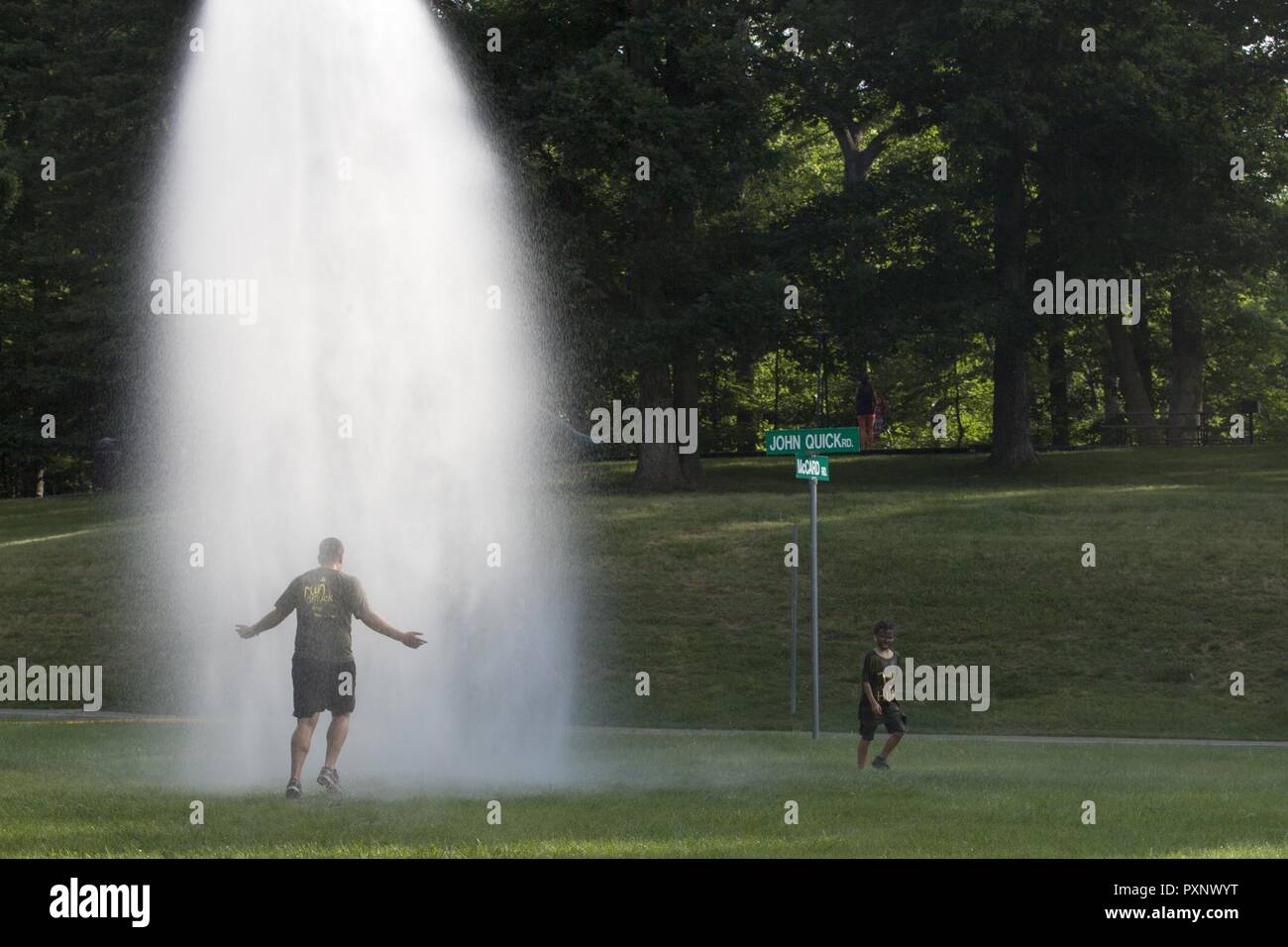 A participant runs through a water hose during the annual Marine Corps ...