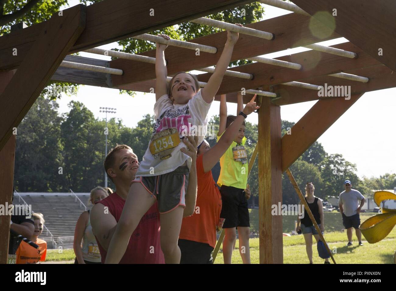 Participants engage in an obstacle during the annual Marine Corps ...