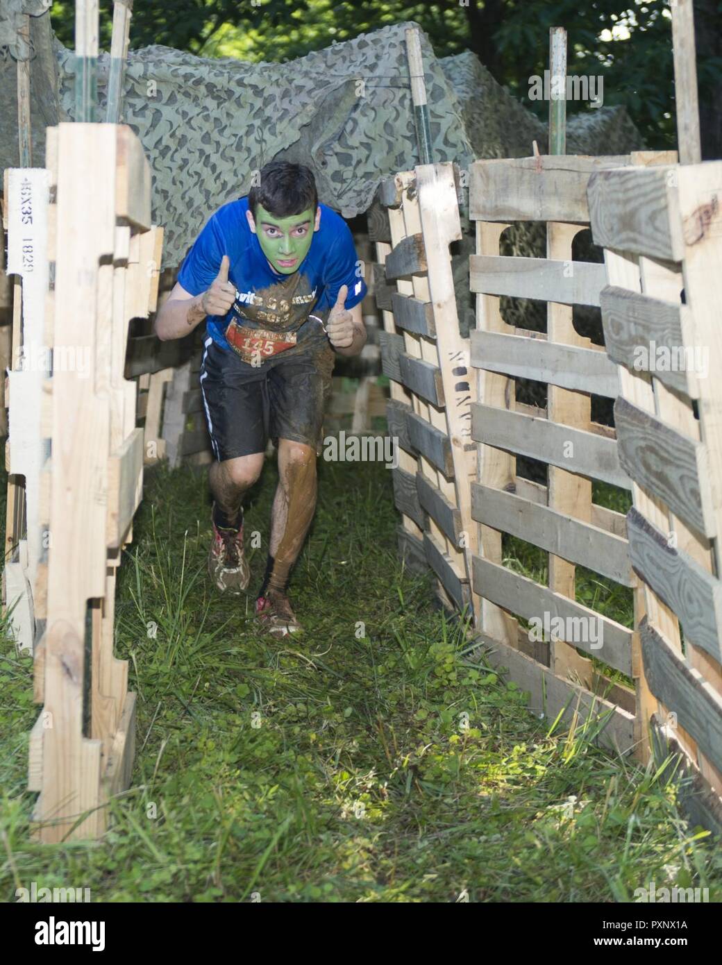 A participant maneuvers through an obstacle during the annual Marine ...