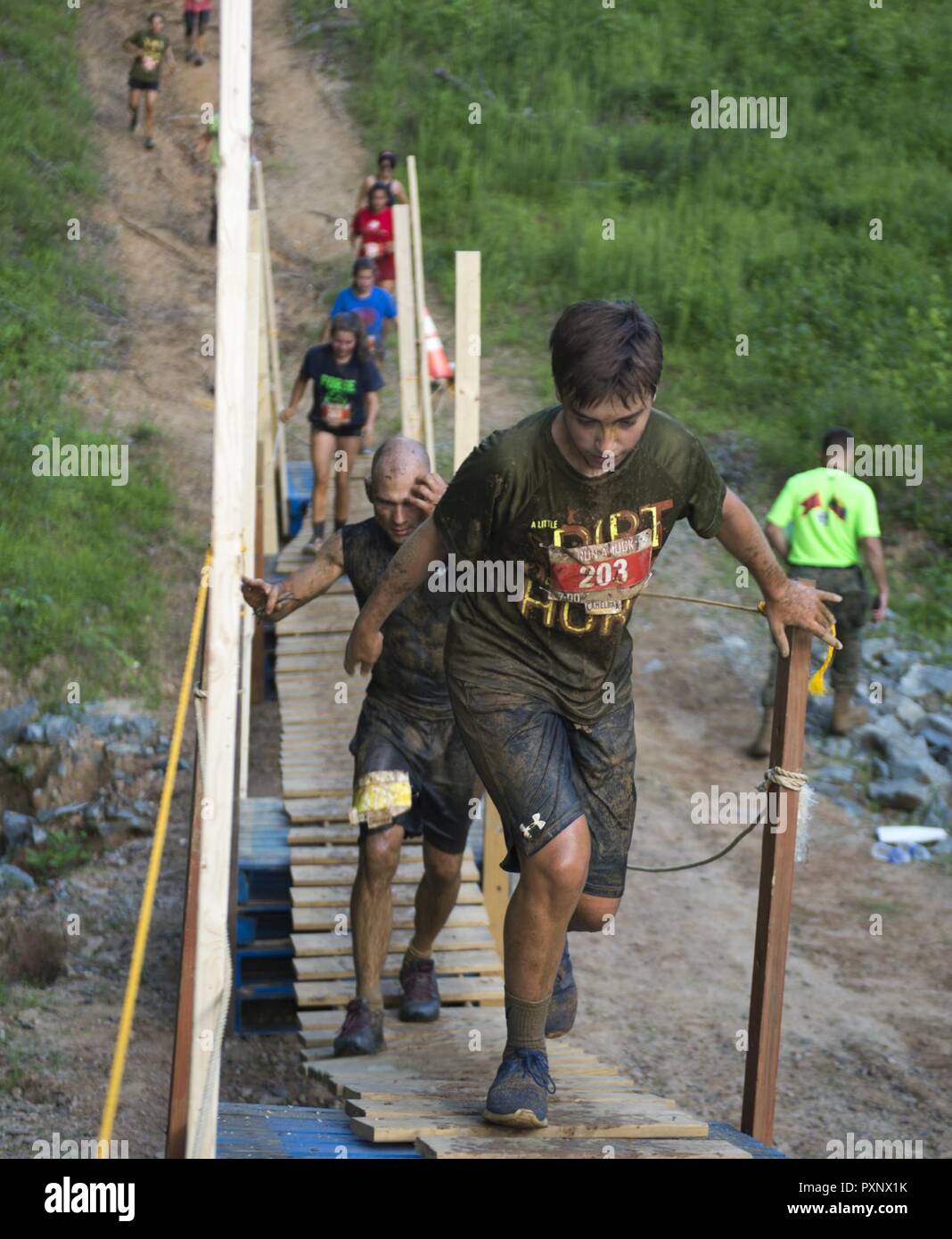 Participants maneuver through an obstacle during the annual Marine ...