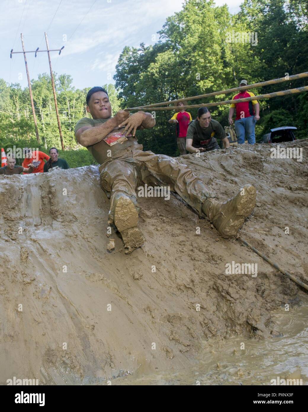 A U.S. Marine maneuvers through an obstacle during the annual Marine ...