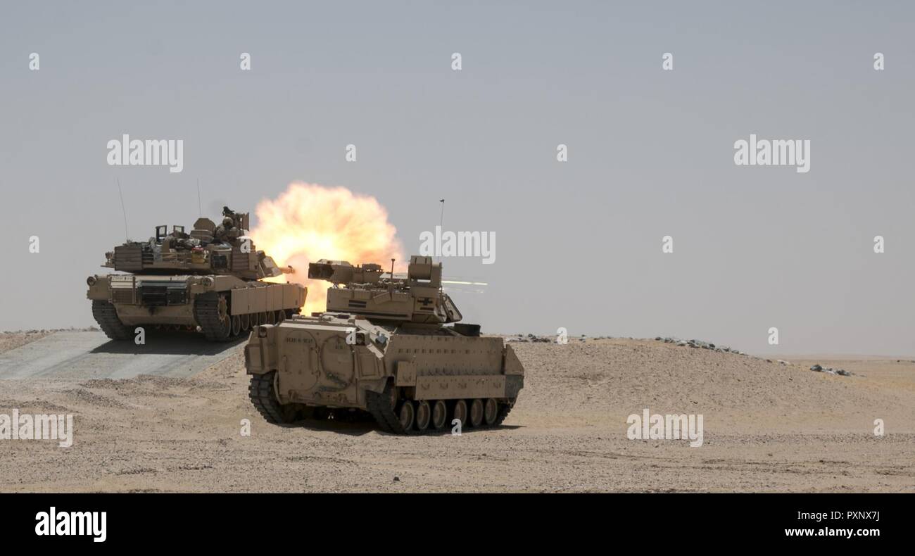 An M1A2 Abrams Main Battle Tank crew engages targets while providing ...