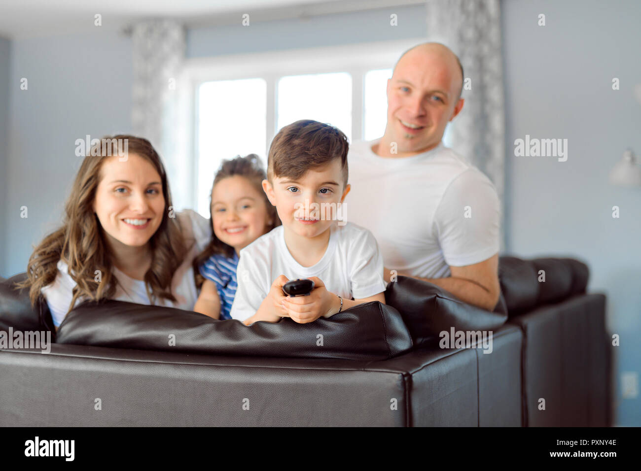 Portrait family four watching tv hi-res stock photography and images ...