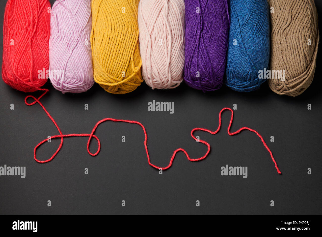 balls of woolen thread for knitting on black background Stock Photo - Alamy