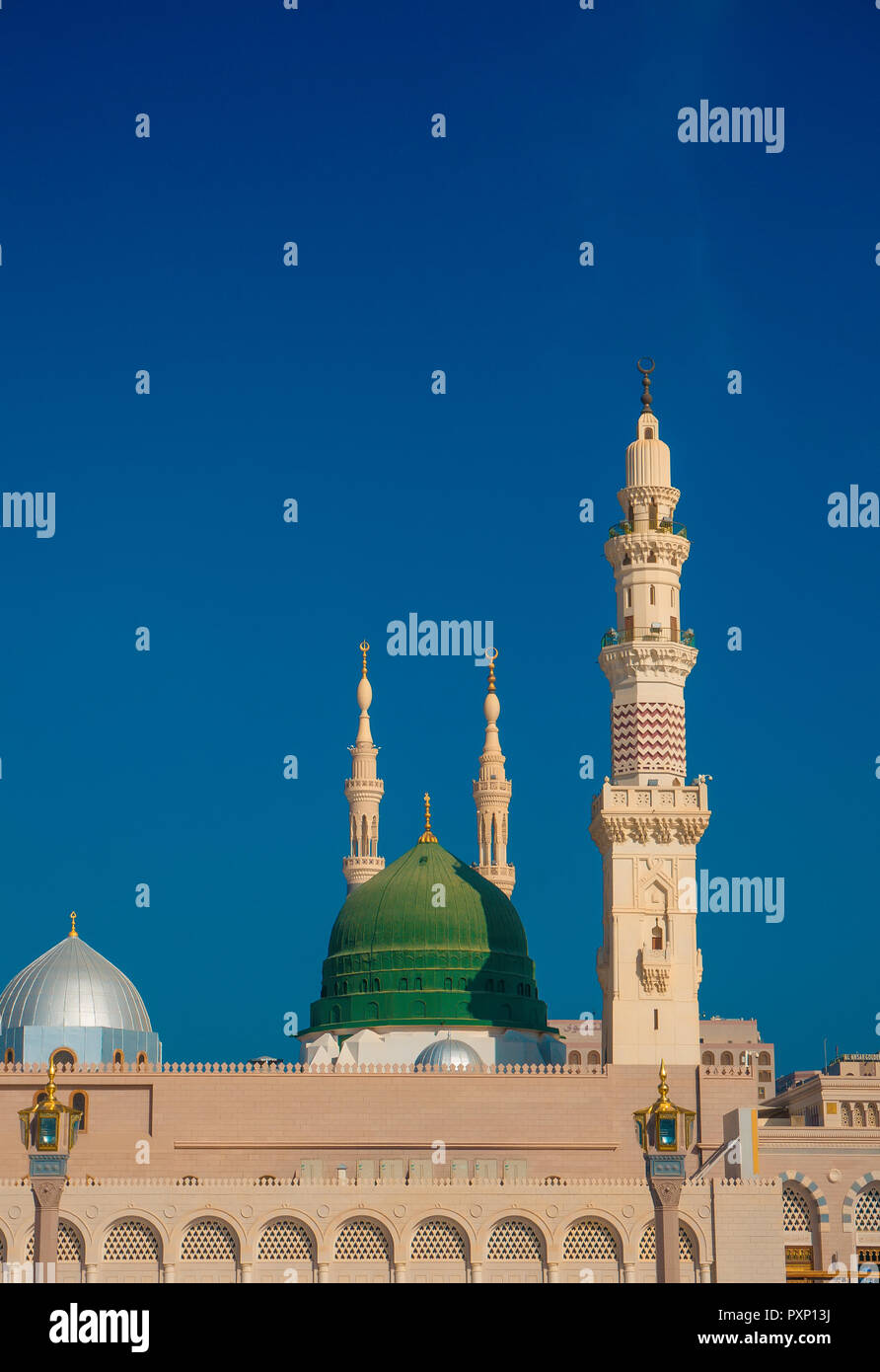 Exterior view of minarets and green dome of a mosque taken off the ...