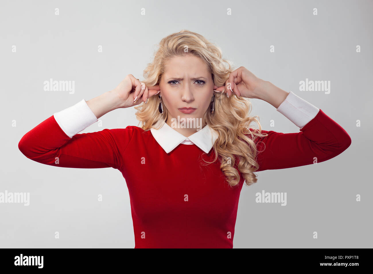 Upset woman stopping ears Stock Photo - Alamy