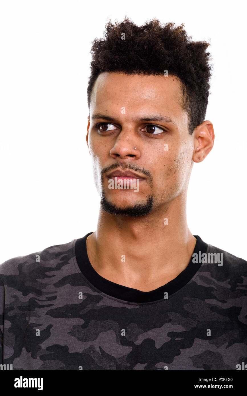 Face of young African man thinking while looking at distance Stock ...