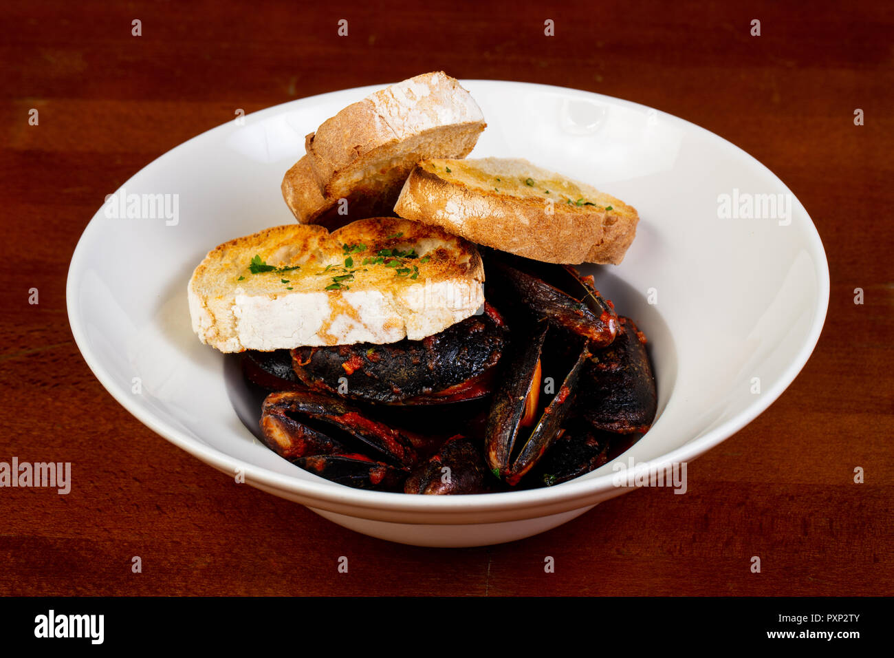 Baked Mussels with garlic bread Stock Photo - Alamy