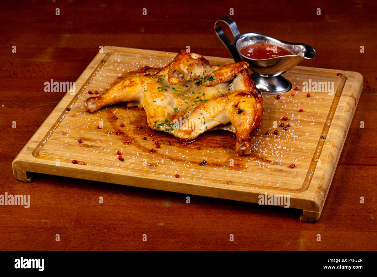 Roasted young chicken with sauce Stock Photo - Alamy