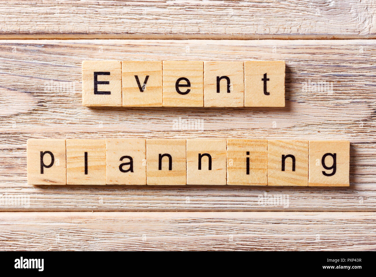 Event planning word written on wood block. Event planning text on table ...
