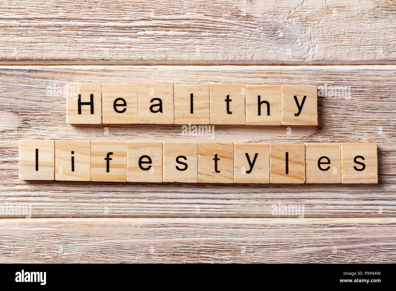 Healthy lifestyle word written on wood block. Healthy lifestyle text on ...