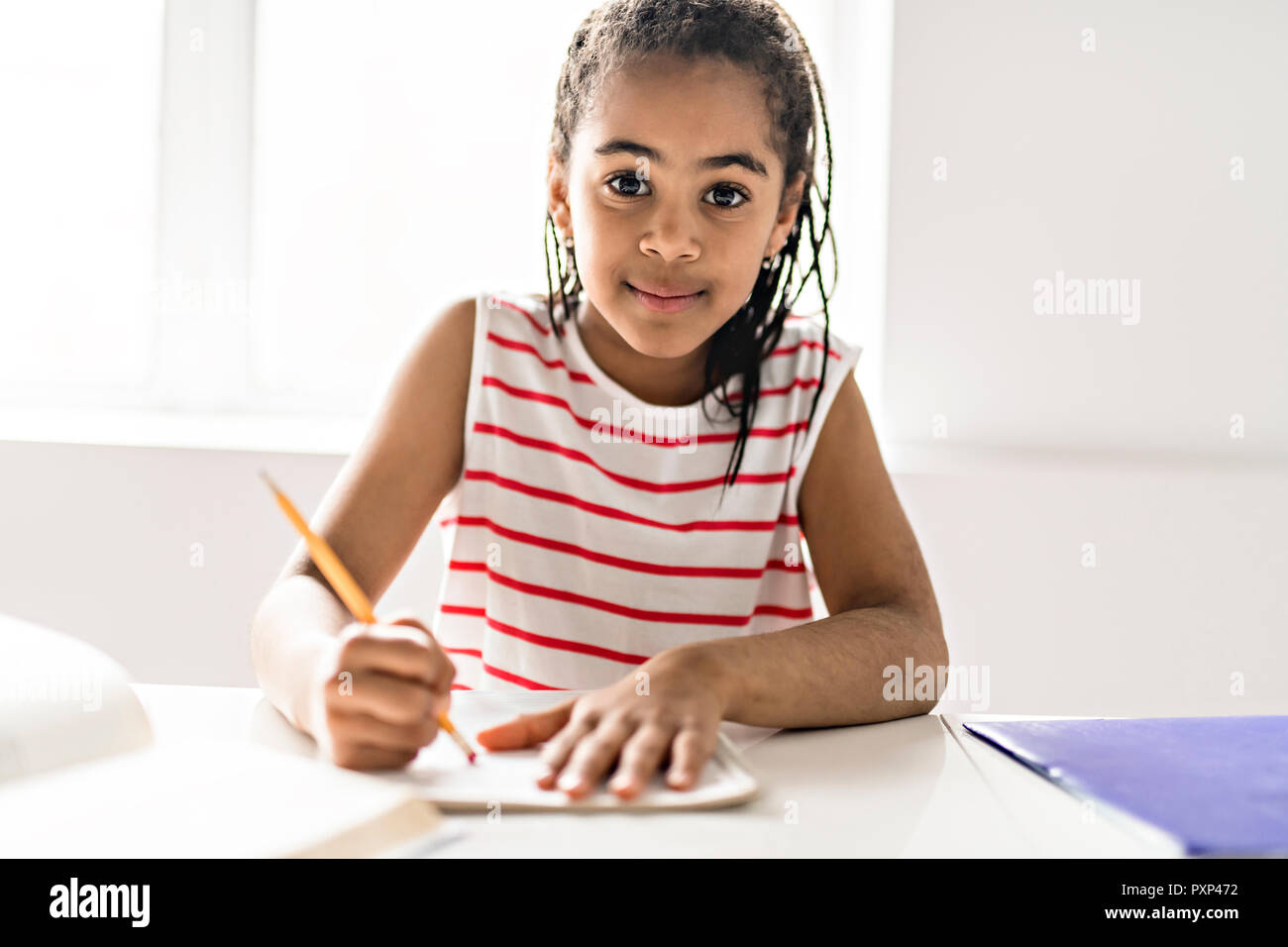 A cute Black girl doing homework at home Stock Photo - Alamy