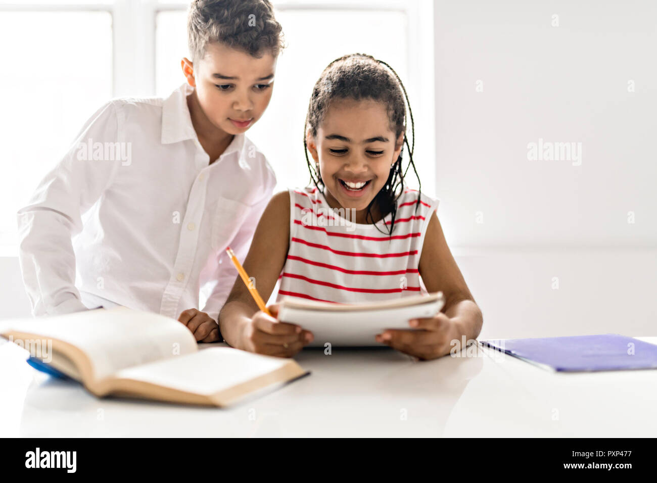Black child writing with pencil hi-res stock photography and images - Alamy