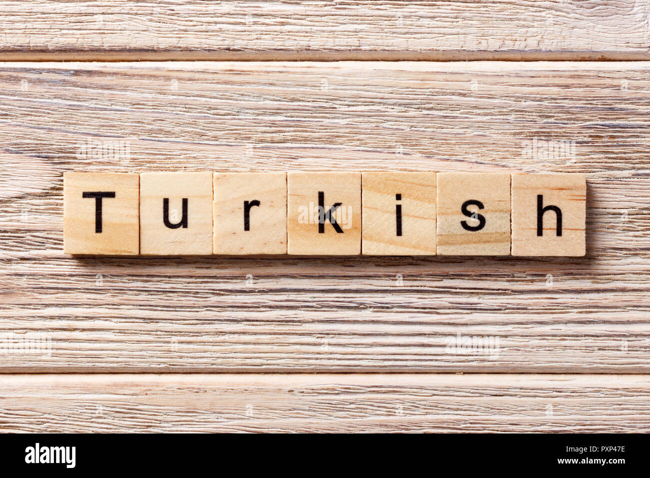 Turkish word written on wood block. Turkish text on table, concept ...