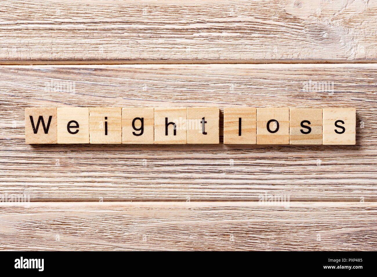 Weight loss word written on wood block. Weight loss text on table ...